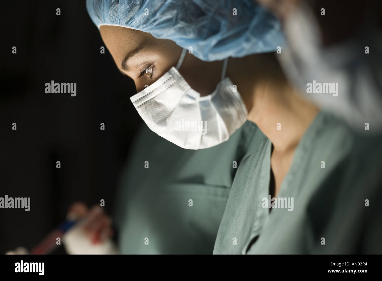 Profile of a female surgeon operating Stock Photo - Alamy