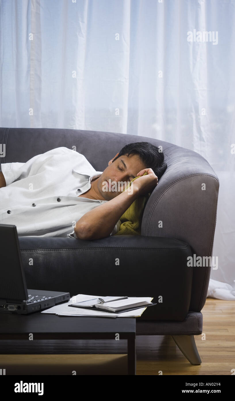 Man sleeping on a couch Stock Photo - Alamy
