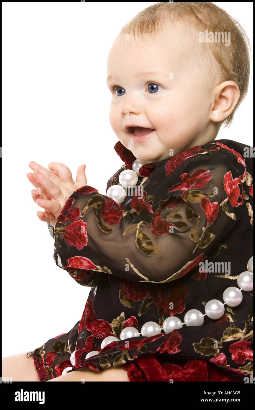 Profile of a baby girl clapping hands and smiling Stock Photo - Alamy