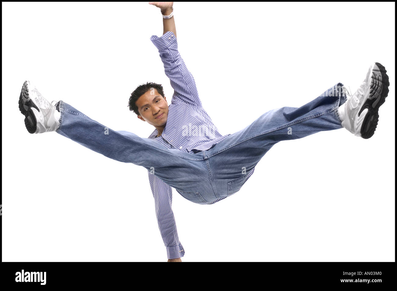 Portrait of a teenage boy jumping with legs stretched out Stock Photo ...