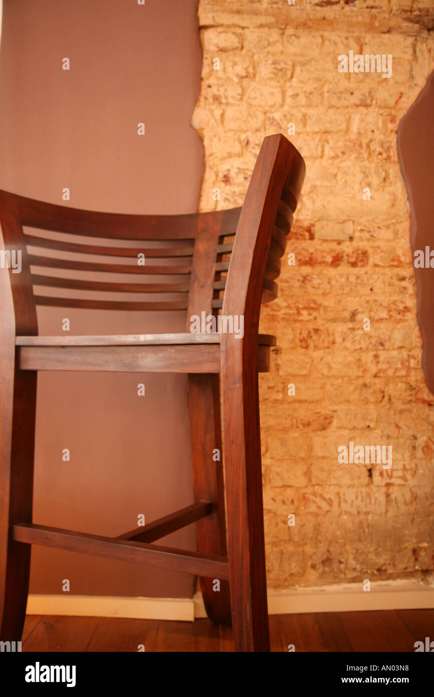 wooden chair with brick wall behind Stock Photo - Alamy
