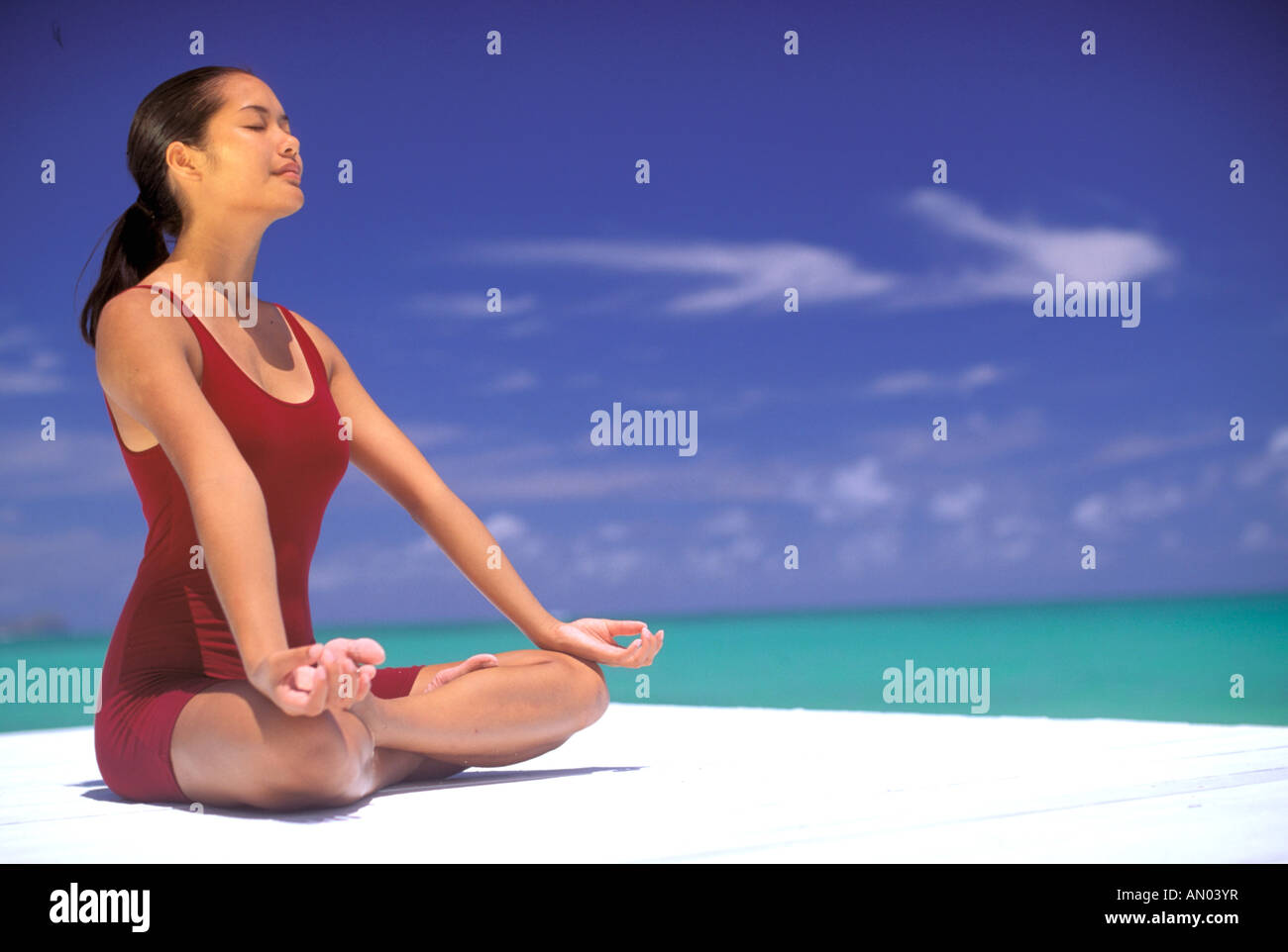 USA, Hawaiian Islands. Woman performing yoga on oceanside dock Stock ...