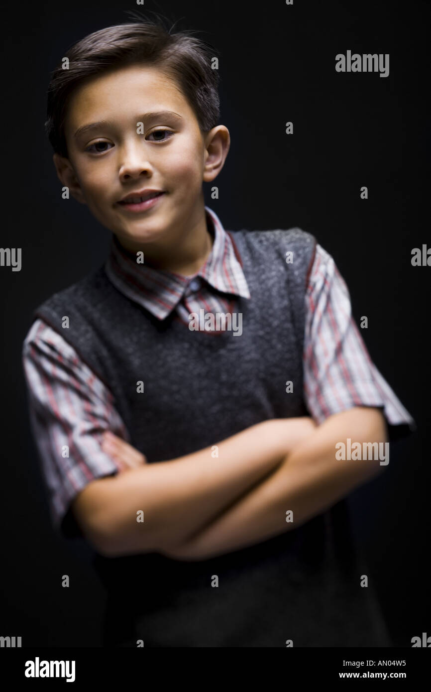 Portrait of a boy smiling with his arms crossed Stock Photo - Alamy