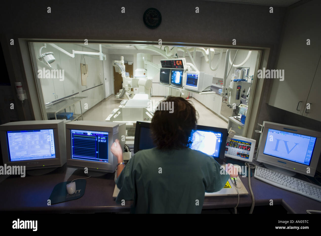 Rear view of a person in a control room of a hospital Stock Photo - Alamy