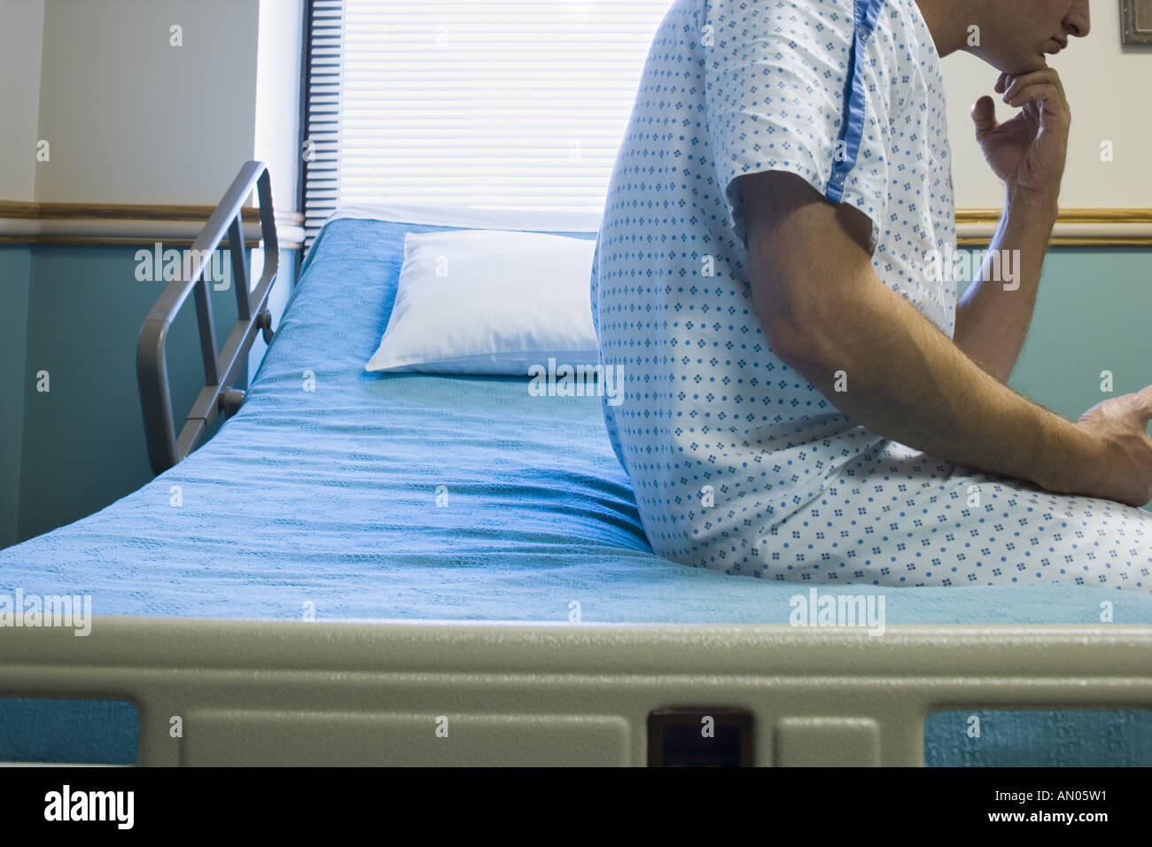Mid section view of a patient sitting on a hospital bed Stock Photo - Alamy