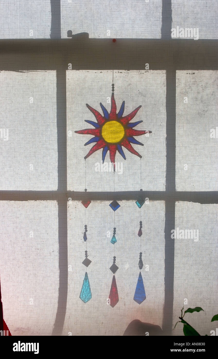 Stained glass sun and rain in window sill Stock Photo - Alamy