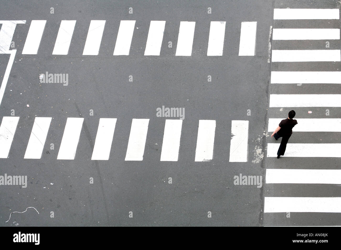 pattern on street pedestrian passage man in black crossing Stock Photo ...