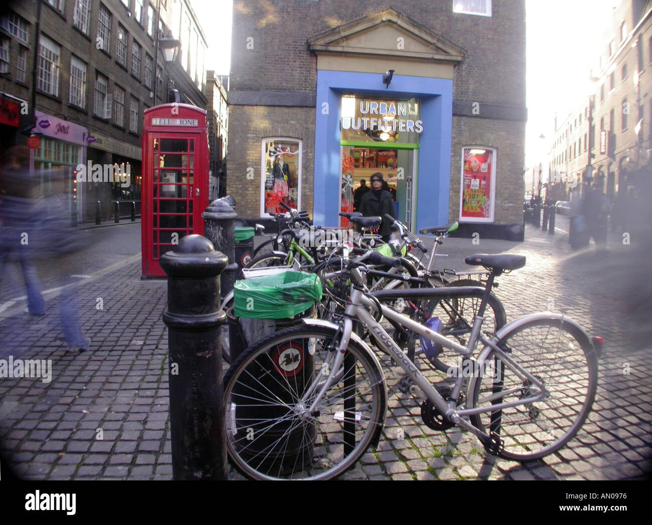Bicycles on Neal Street near Covent Garden London; people passing by in ...