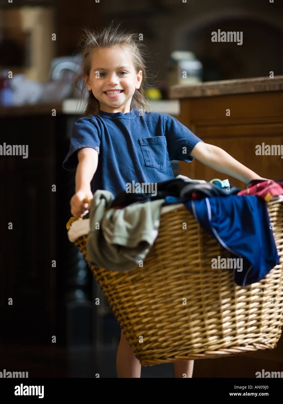 Portrait of a girl carrying a basket of laundry Stock Photo - Alamy