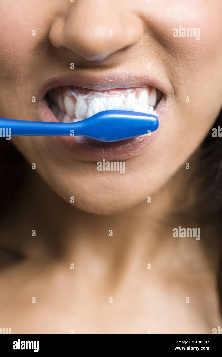 Close up of a young woman brushing her teeth Stock Photo - Alamy