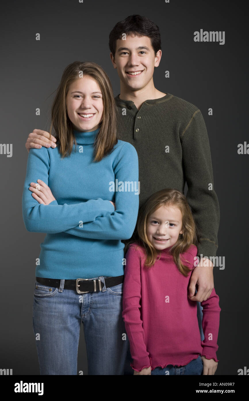 Portrait of two parents standing with their daughter and smiling Stock ...