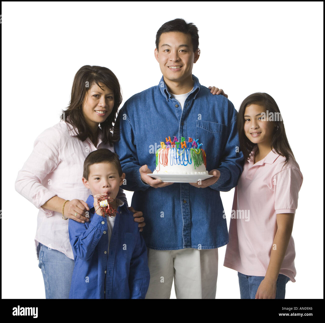 Portrait of a family with a birthday cake Stock Photo - Alamy