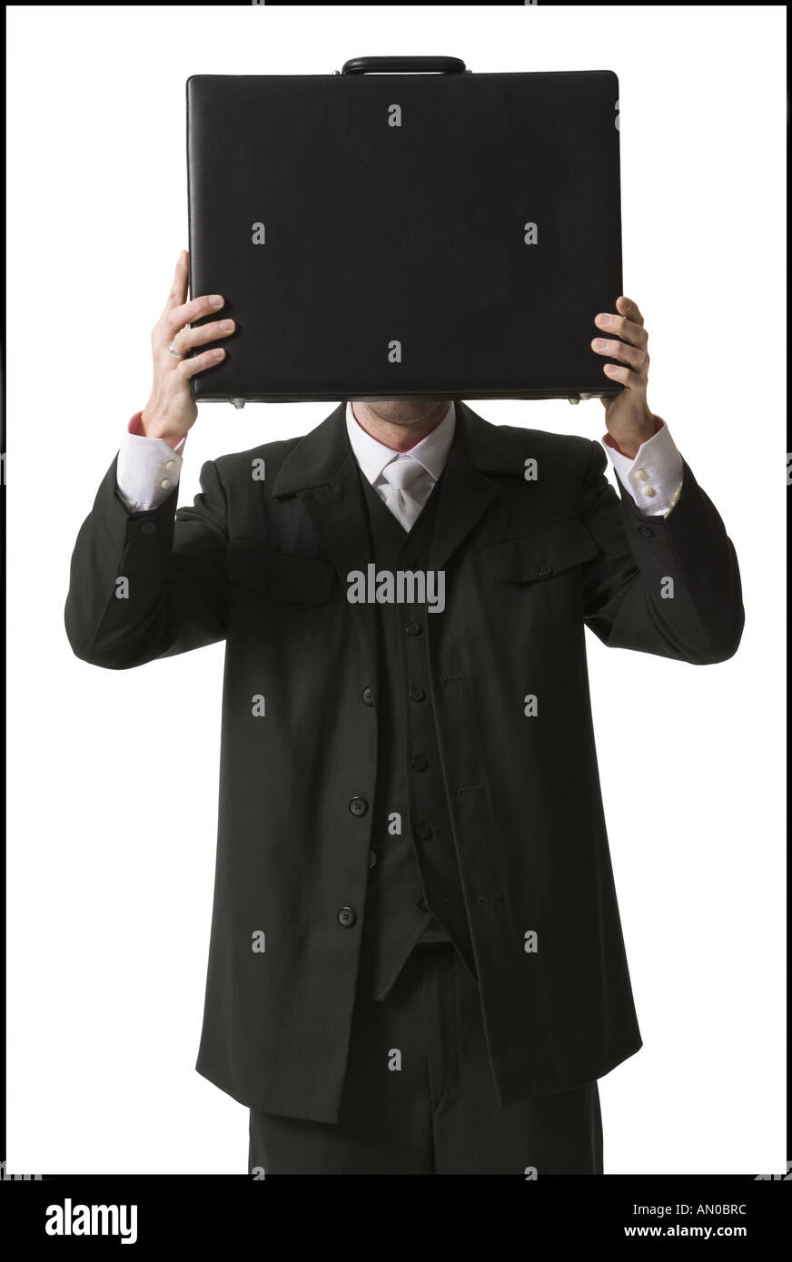 Businessman holding a briefcase in front of his face Stock Photo - Alamy