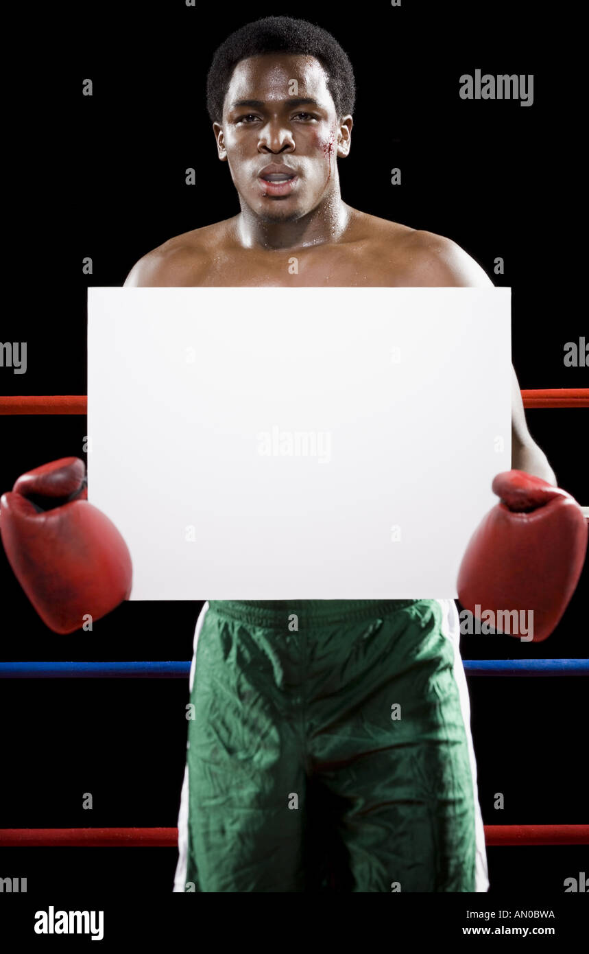 Portrait of a male boxer holding a blank sign Stock Photo - Alamy