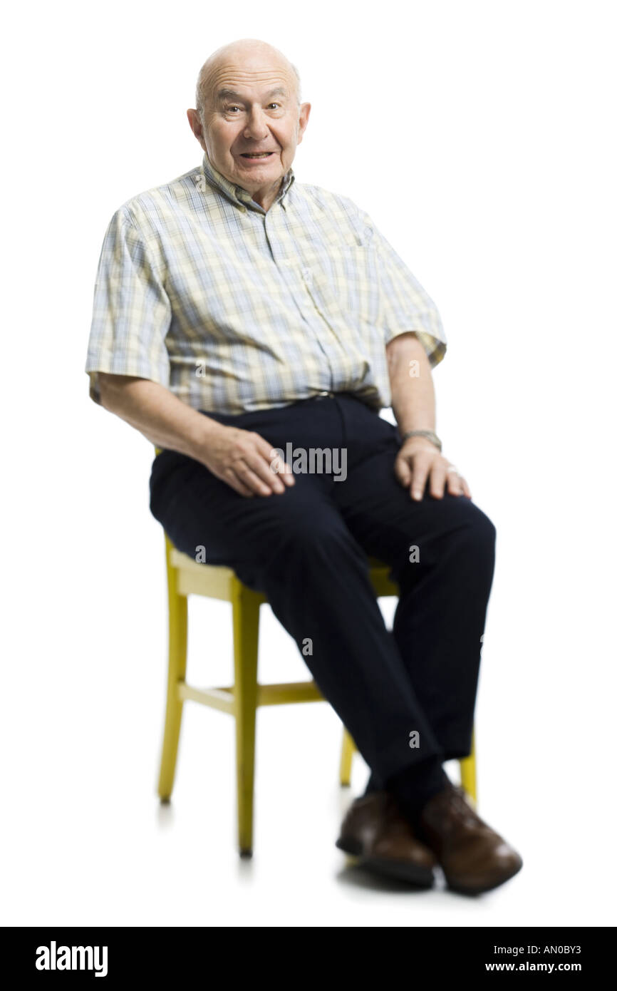 Portrait of a senior man sitting on a chair Stock Photo - Alamy