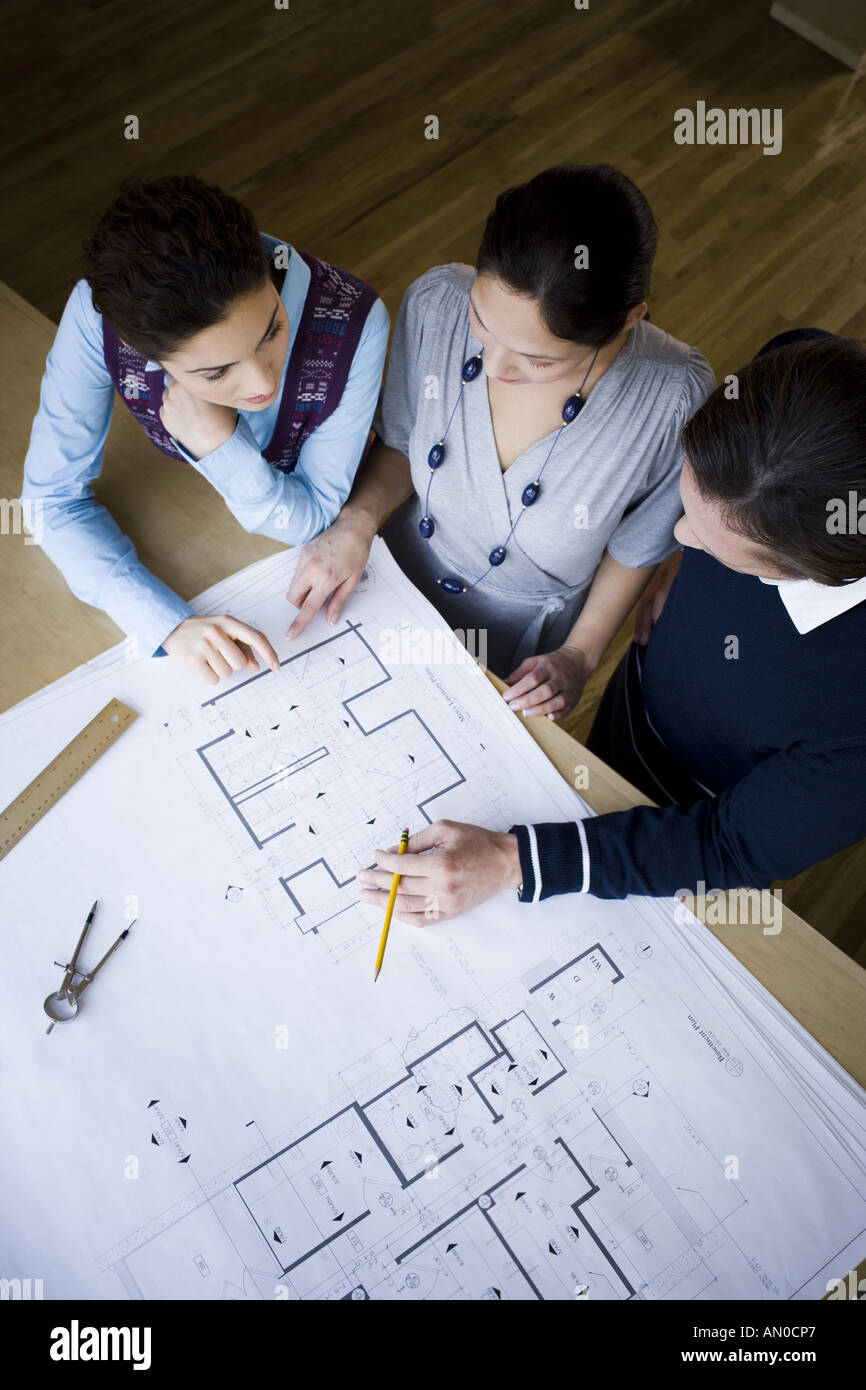 Caucasian architects designing blueprints hi-res stock photography and ...