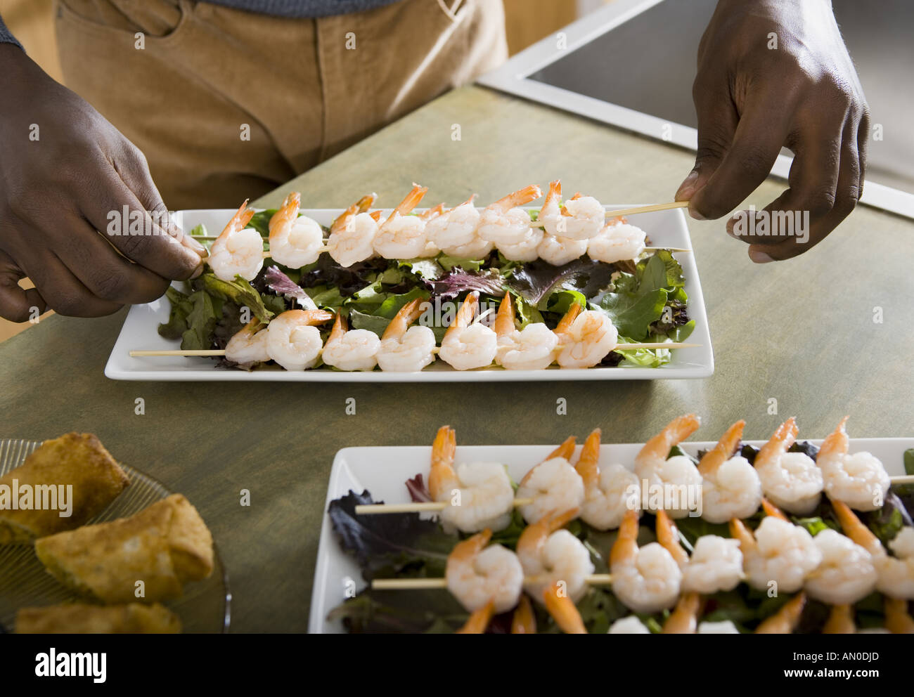 Man s hands arranging shrimp on a platter Stock Photo - Alamy