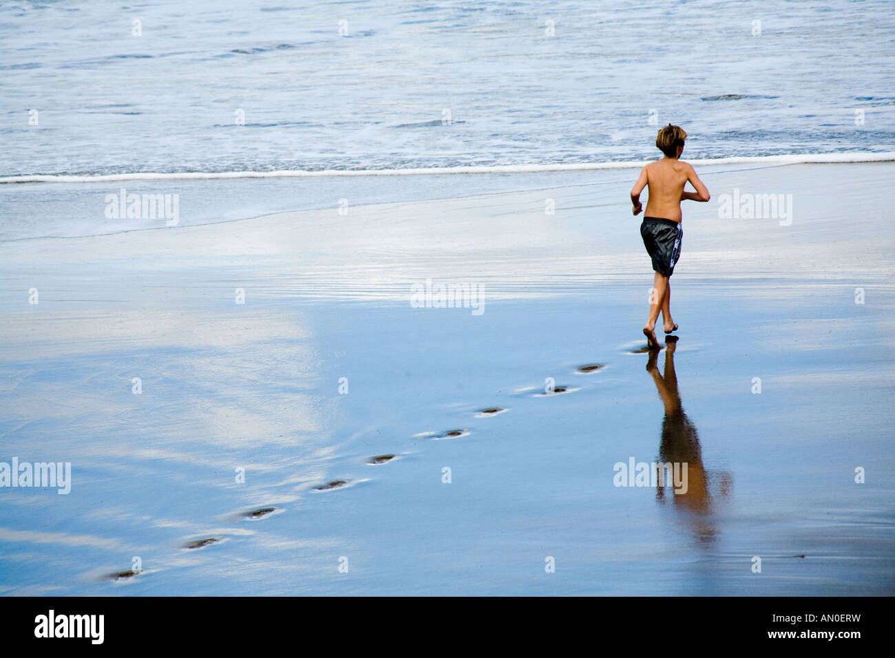 Boy running across the beach, Las Palmas, Canaries Stock Photo - Alamy