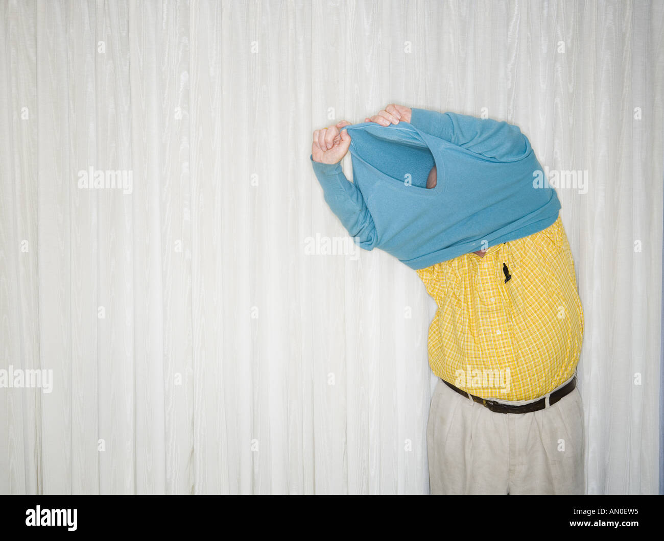 Senior man taking off his sweater Stock Photo - Alamy