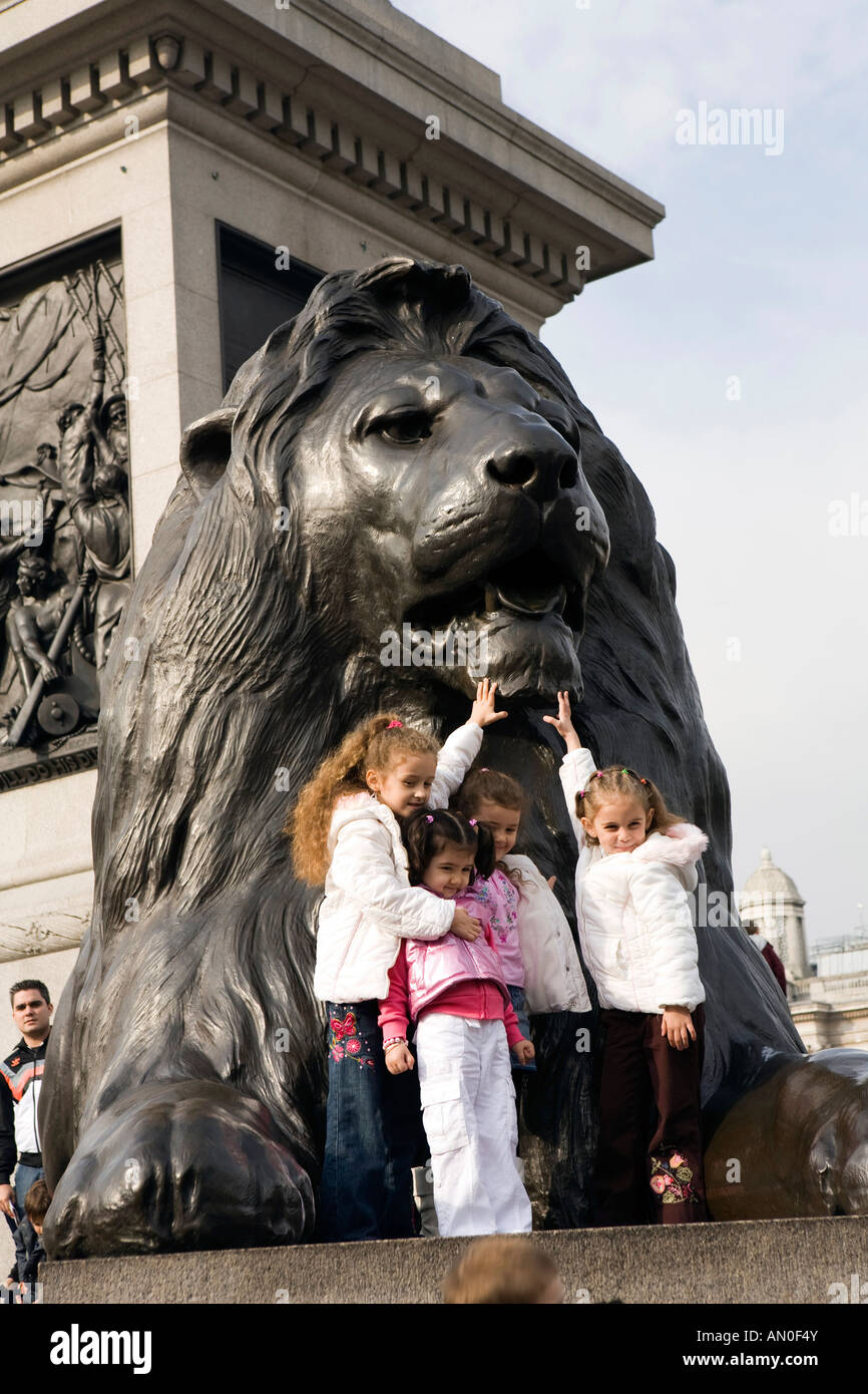UK London Trafalgar Square children posing for photograph by Landseers ...
