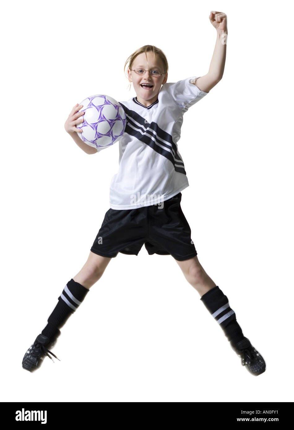 Portrait of a girl jumping with a soccer ball Stock Photo - Alamy