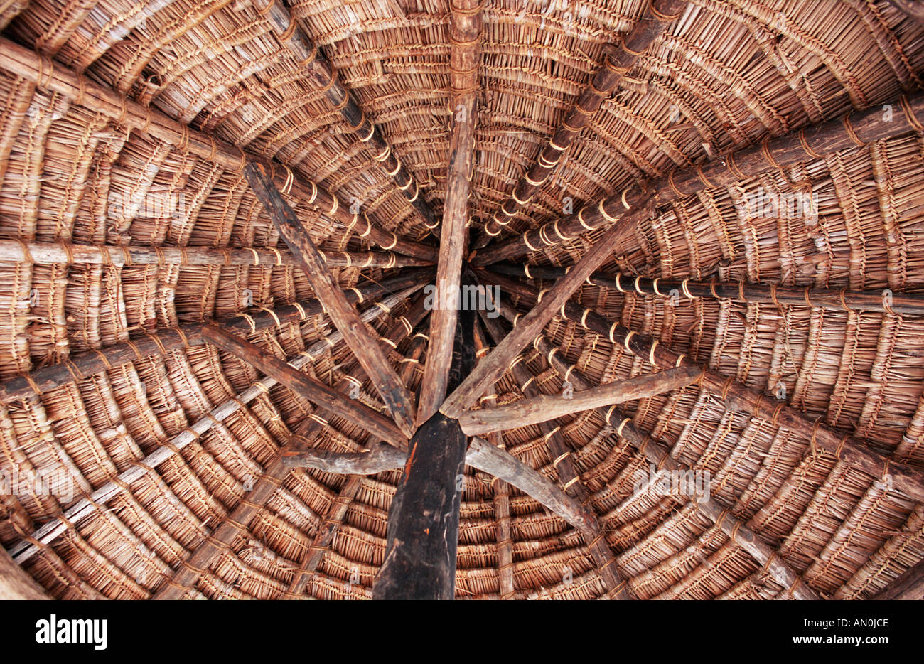 Handmade construction of a thatch parasol viewed from a sunbed Pole ...