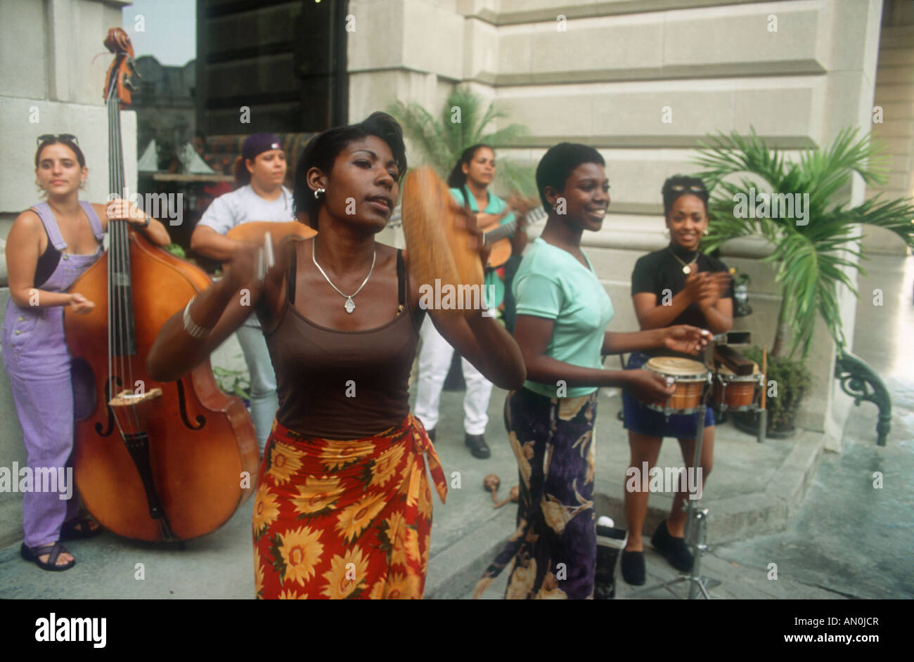 Group of women playing musical instruments outside restaurant in Havana ...