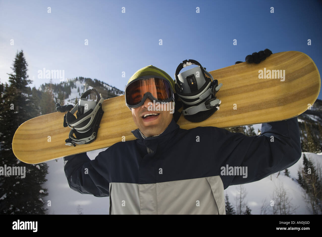 Portrait of an adult man holding a snowboard on his shoulder Stock ...