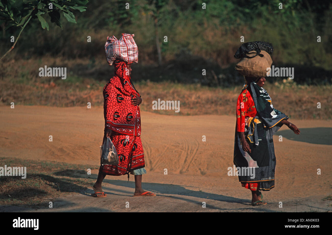 Rural scene on Mafia island Woman Islanders walking down the road in ...