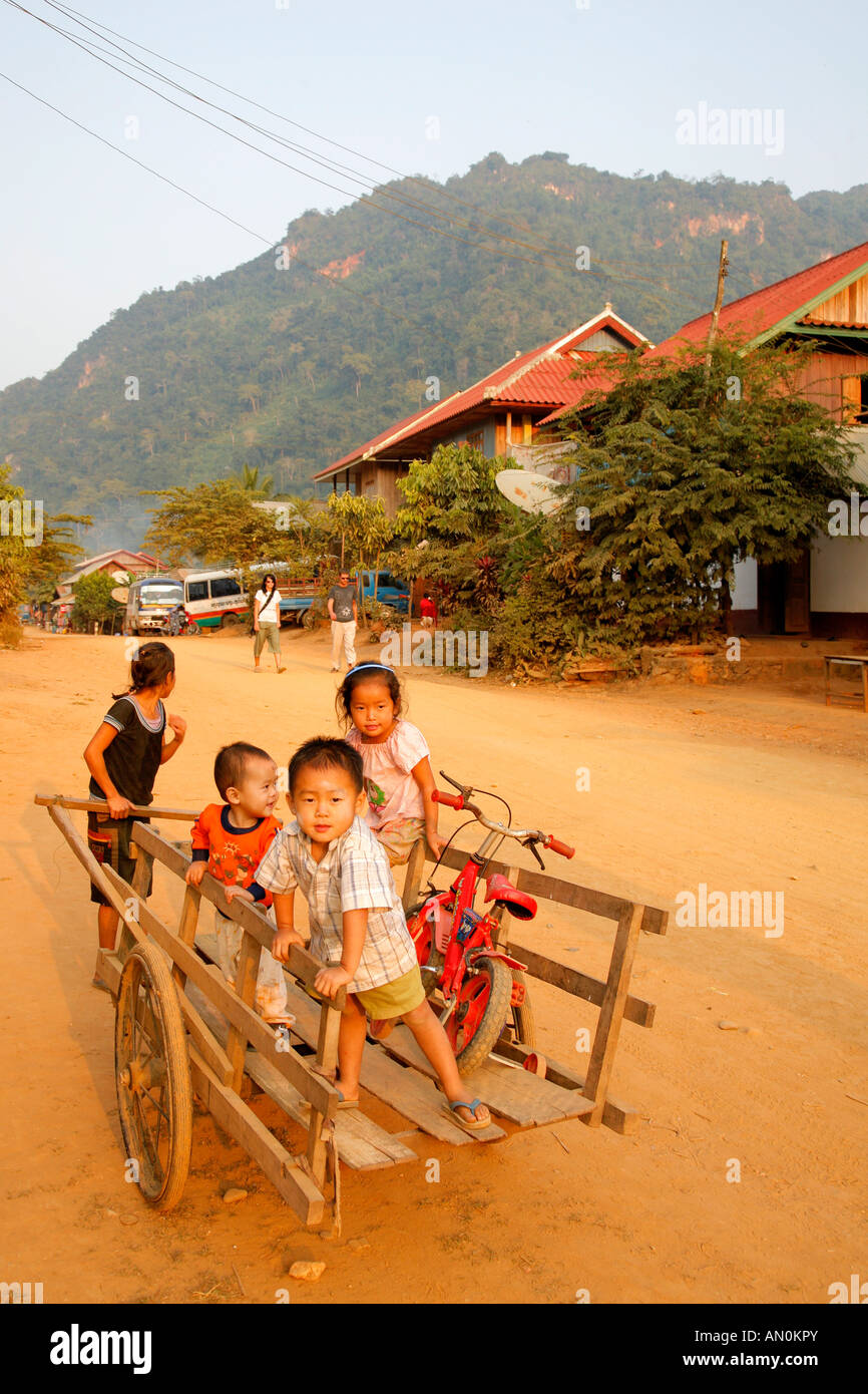 Kids in a rural village in Northern Laos playing with a hand cart Stock ...
