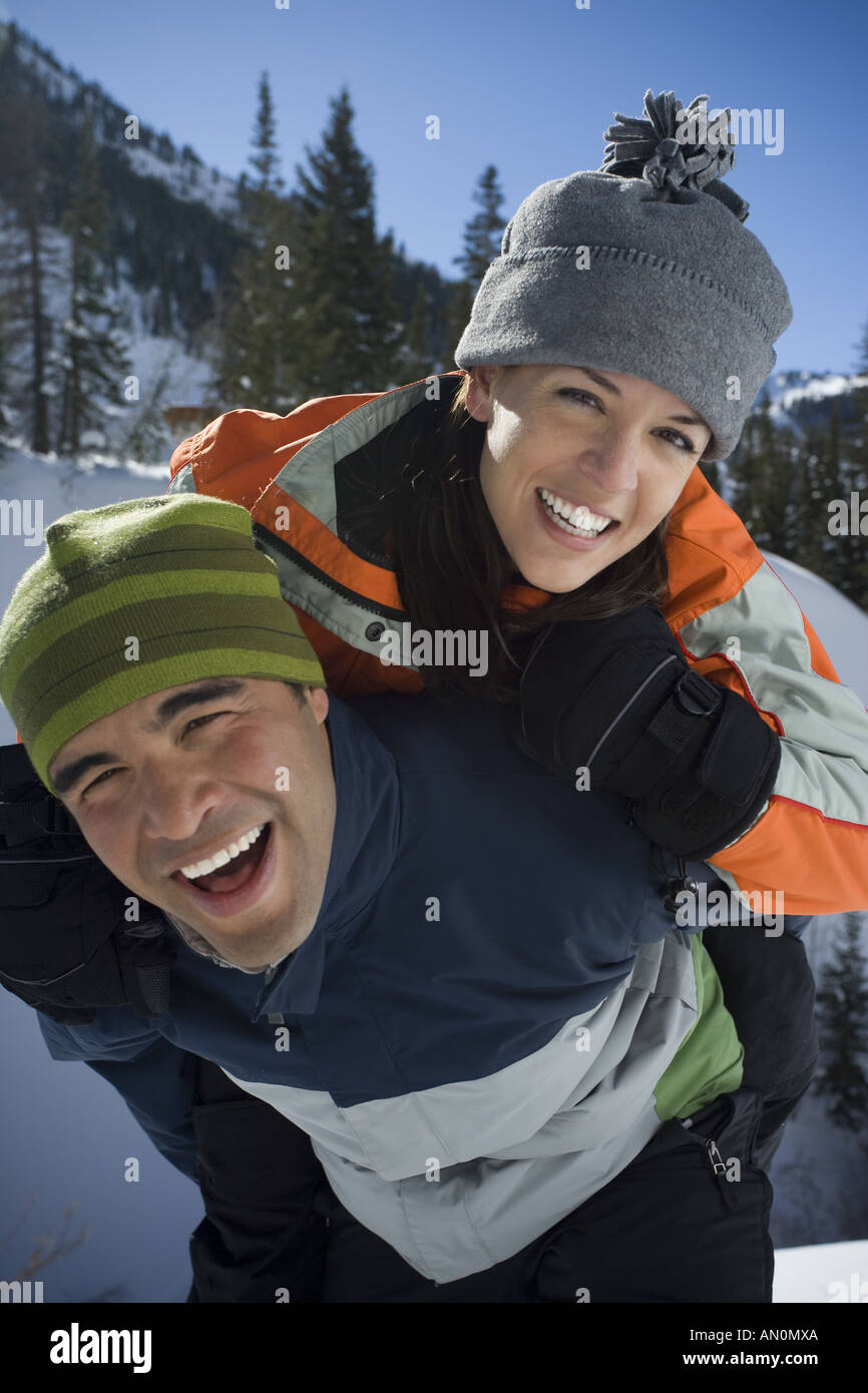 Portrait of a woman ridding piggyback on a man Stock Photo - Alamy