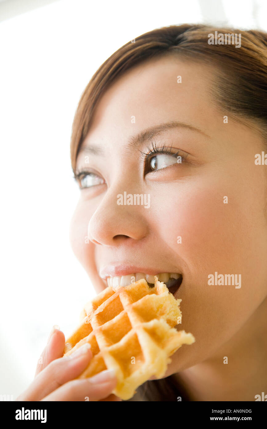 Japanese woman eating sweets Stock Photo - Alamy