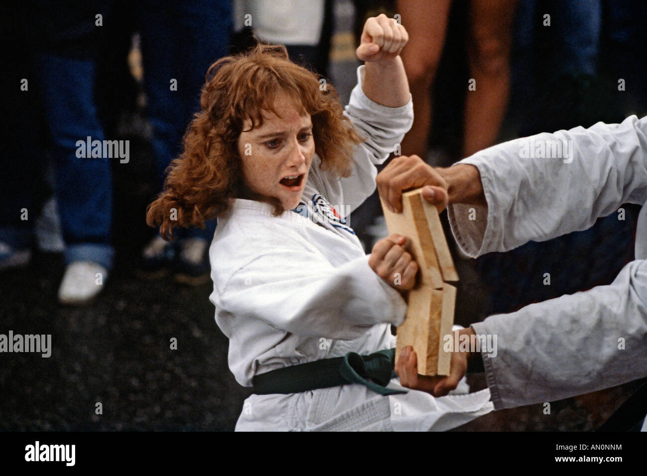 Female breaking boards with bare fist in a karate demonstration Stock ...