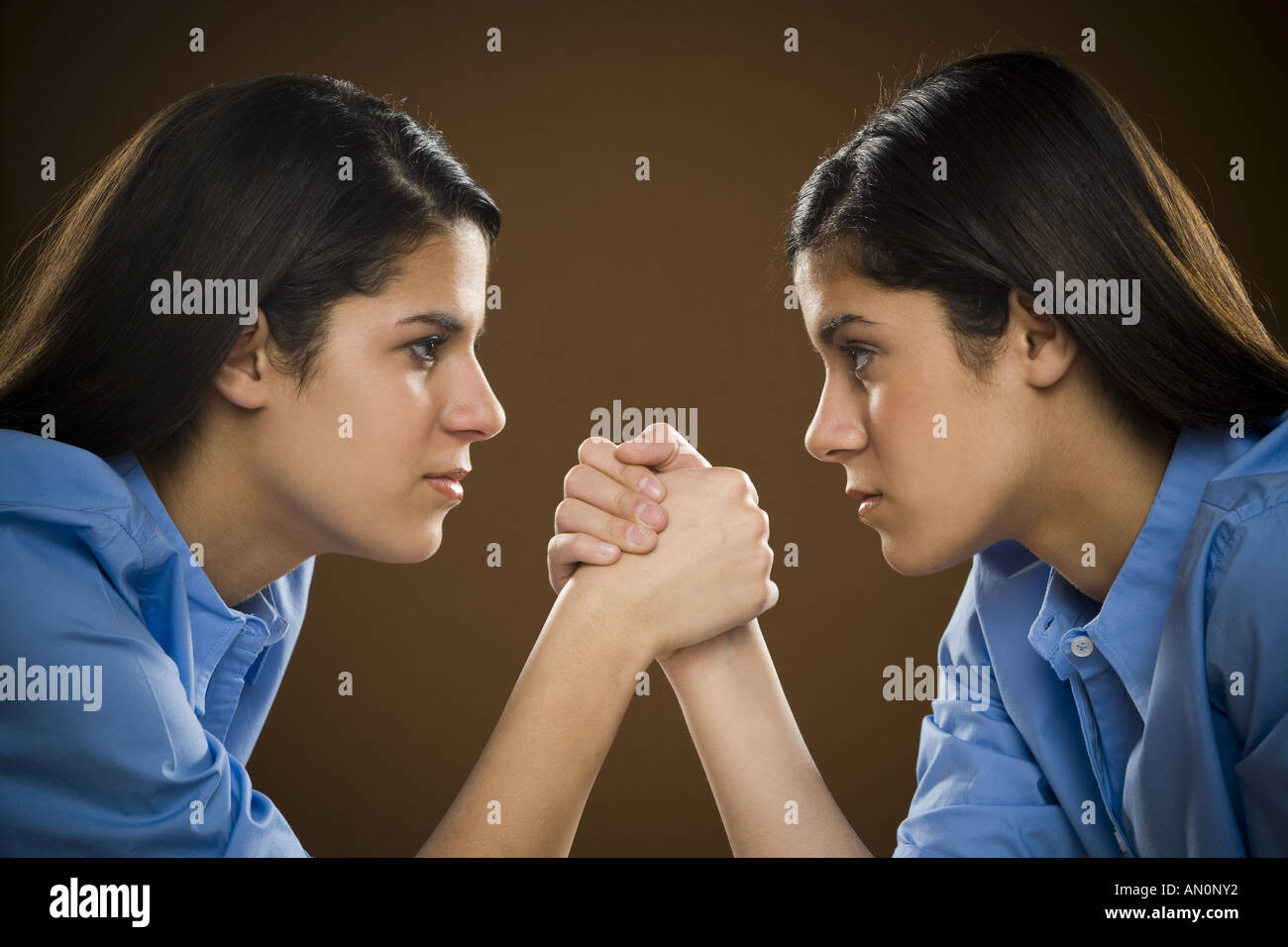 Profile of two teenage girls arm wrestling Stock Photo: 8785009 - Alamy