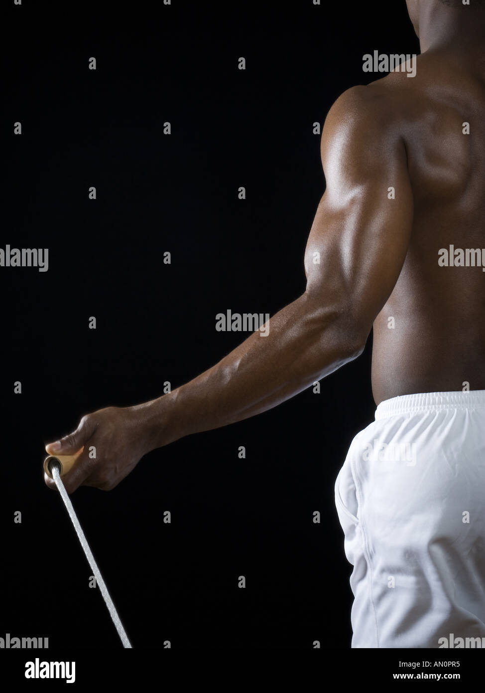 Mid section view of a young man holding a jump rope Stock Photo - Alamy