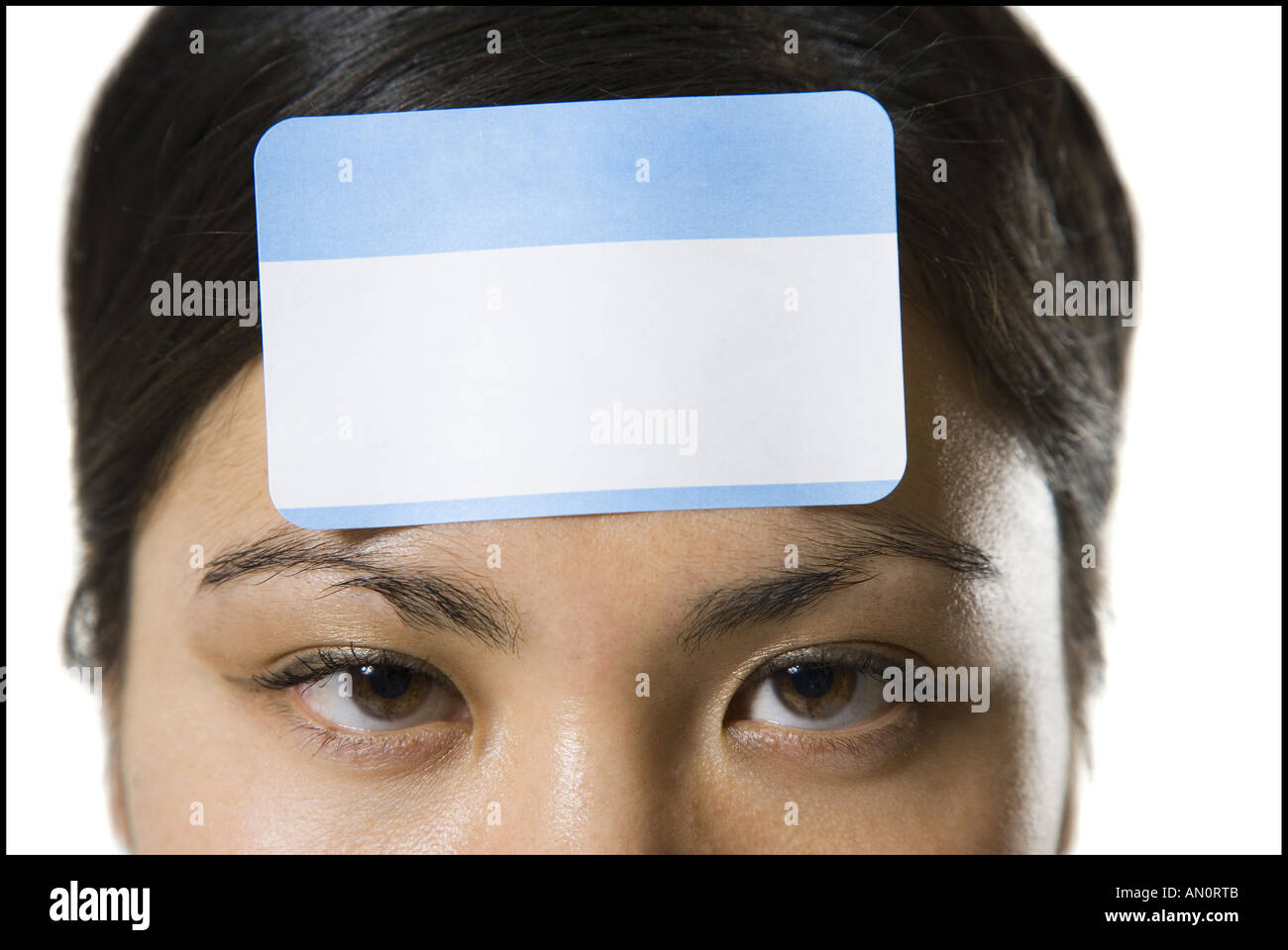 Portrait of a young woman with a blank name tag on her forehead Stock ...