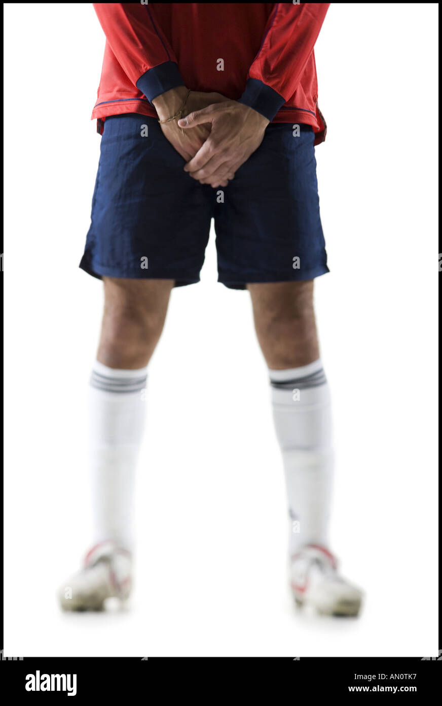 Low section view of a young man protecting his groin Stock Photo - Alamy