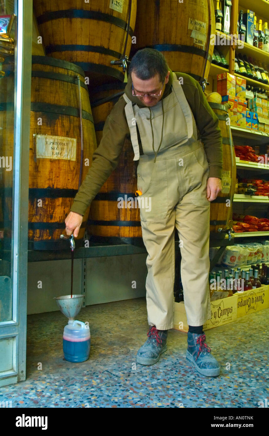 Man pouring wine from a barrel Barcelona Spain EU Stock Photo - Alamy
