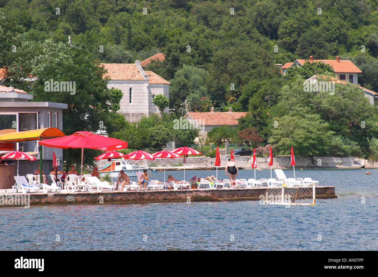 A beach cafe with colourful sun shade umbrellas in Kamenari. Montenegro ...