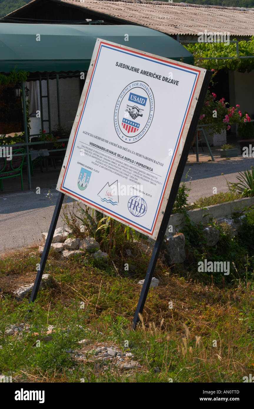 A road side bar and a sign half falling down saying that USAid is ...