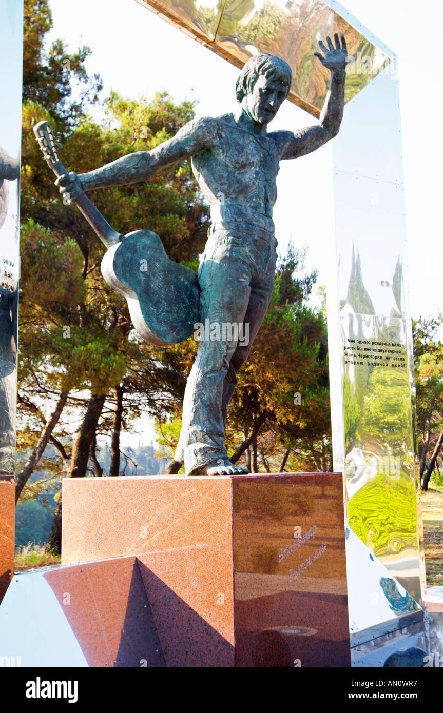A modern statue of a musician with a guitar, framed by a silver square ...