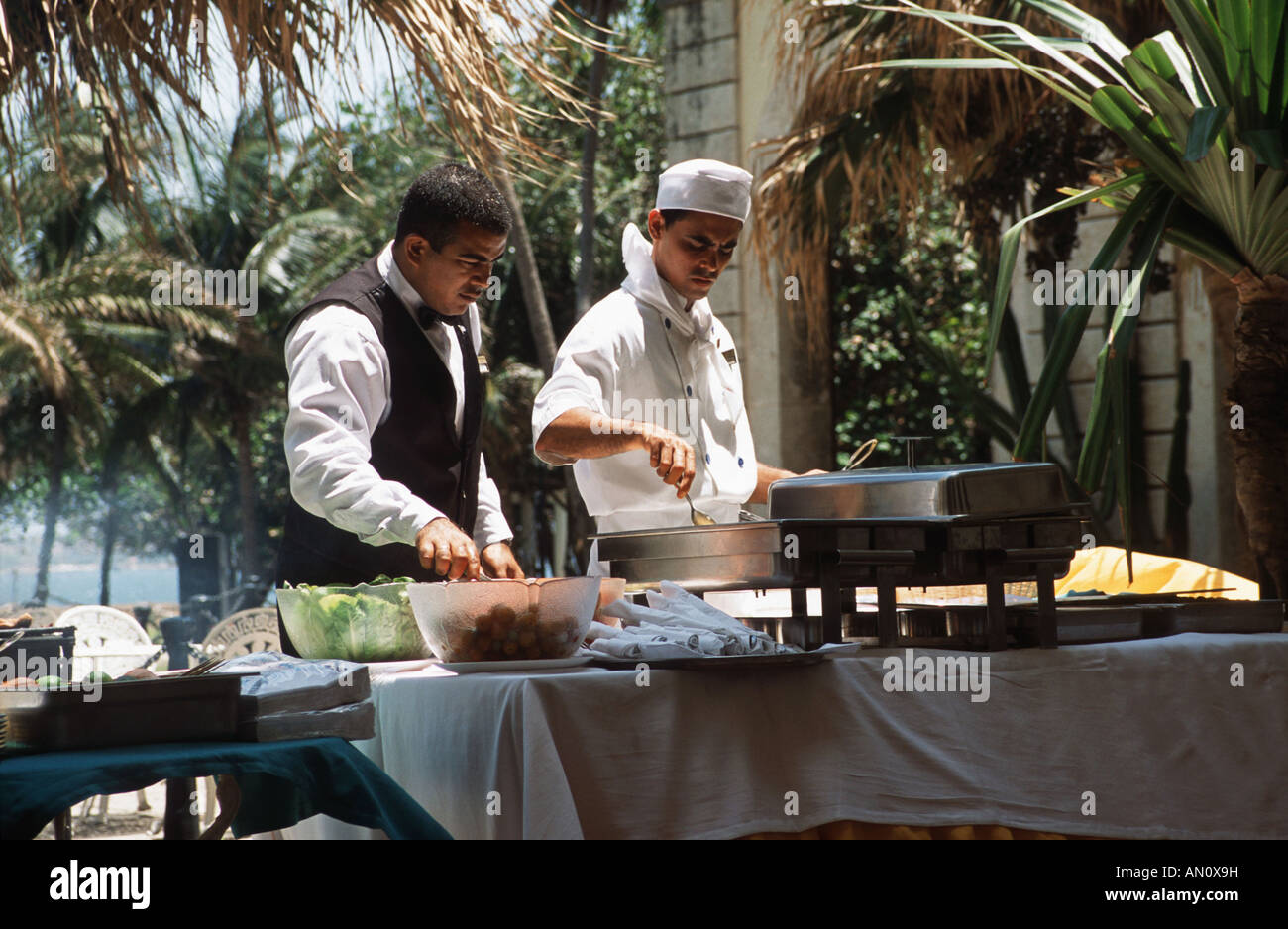 Chef and waiter working behind barbecue at the Hotel Nacional, Havana ...