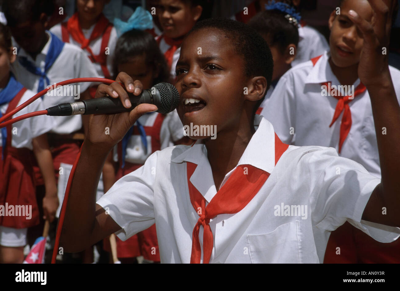Young boy wearing uniform singing into microphone. Cuba Stock Photo - Alamy