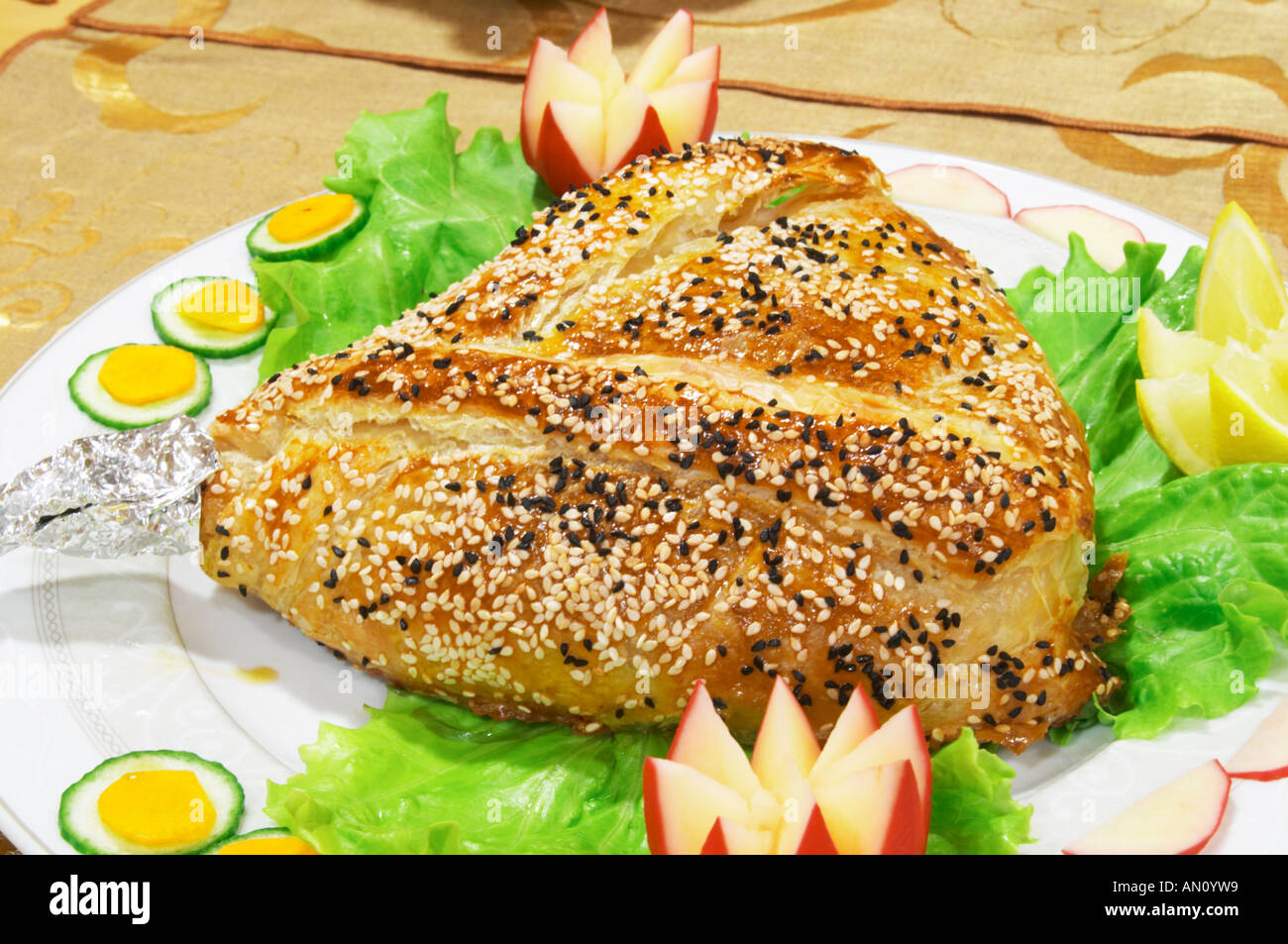Whole baked in the oven leg of lamb with sesame seed decoration en ...