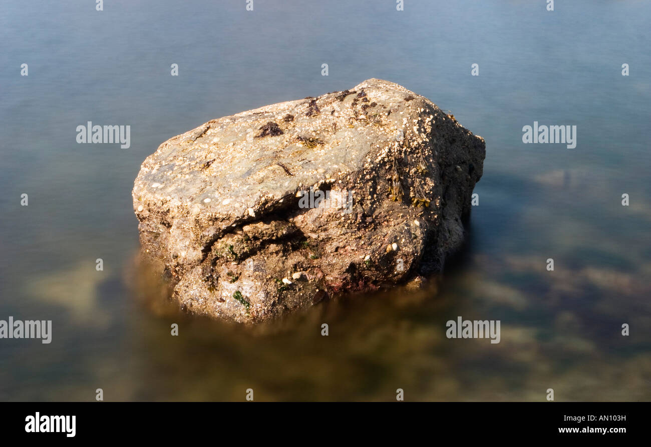 Boulder standing in still water Stock Photo - Alamy