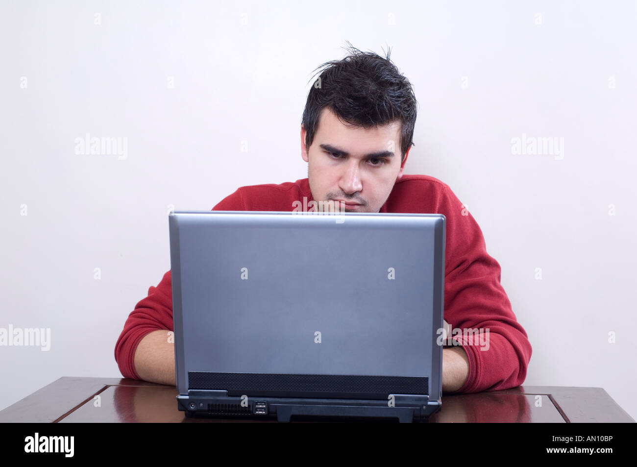 Serious man with laptop computer Stock Photo - Alamy