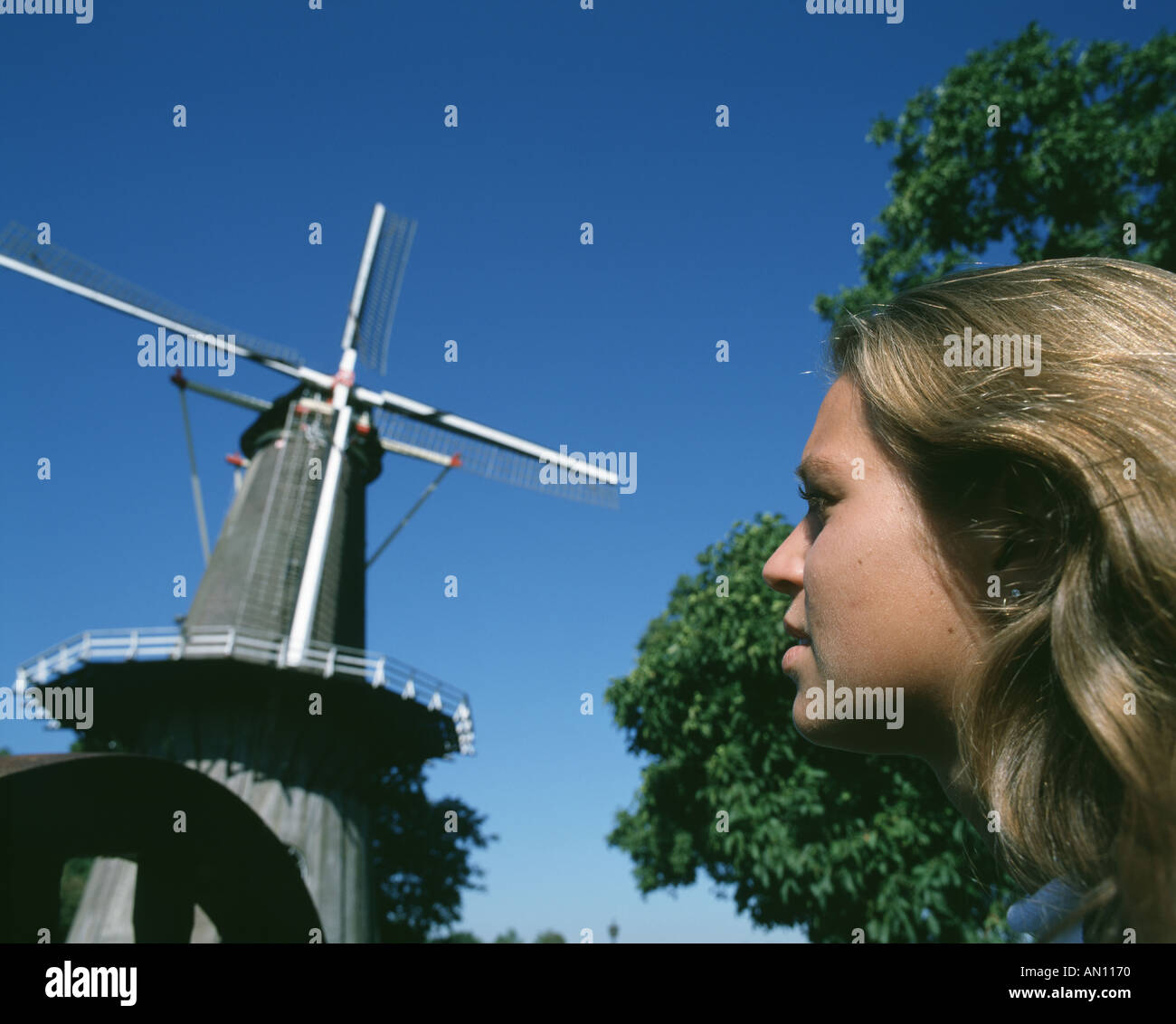 Girl looking at windmill in Buren Holland Stock Photo - Alamy