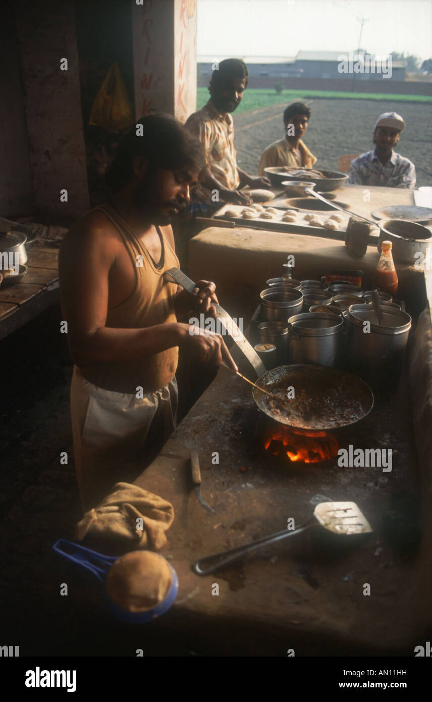 Road side café in India with man cooking Stock Photo - Alamy
