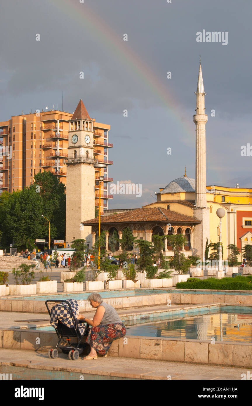 The Ethem Bey Beu Mosque. A woman sitting on the ledge of the fountain ...