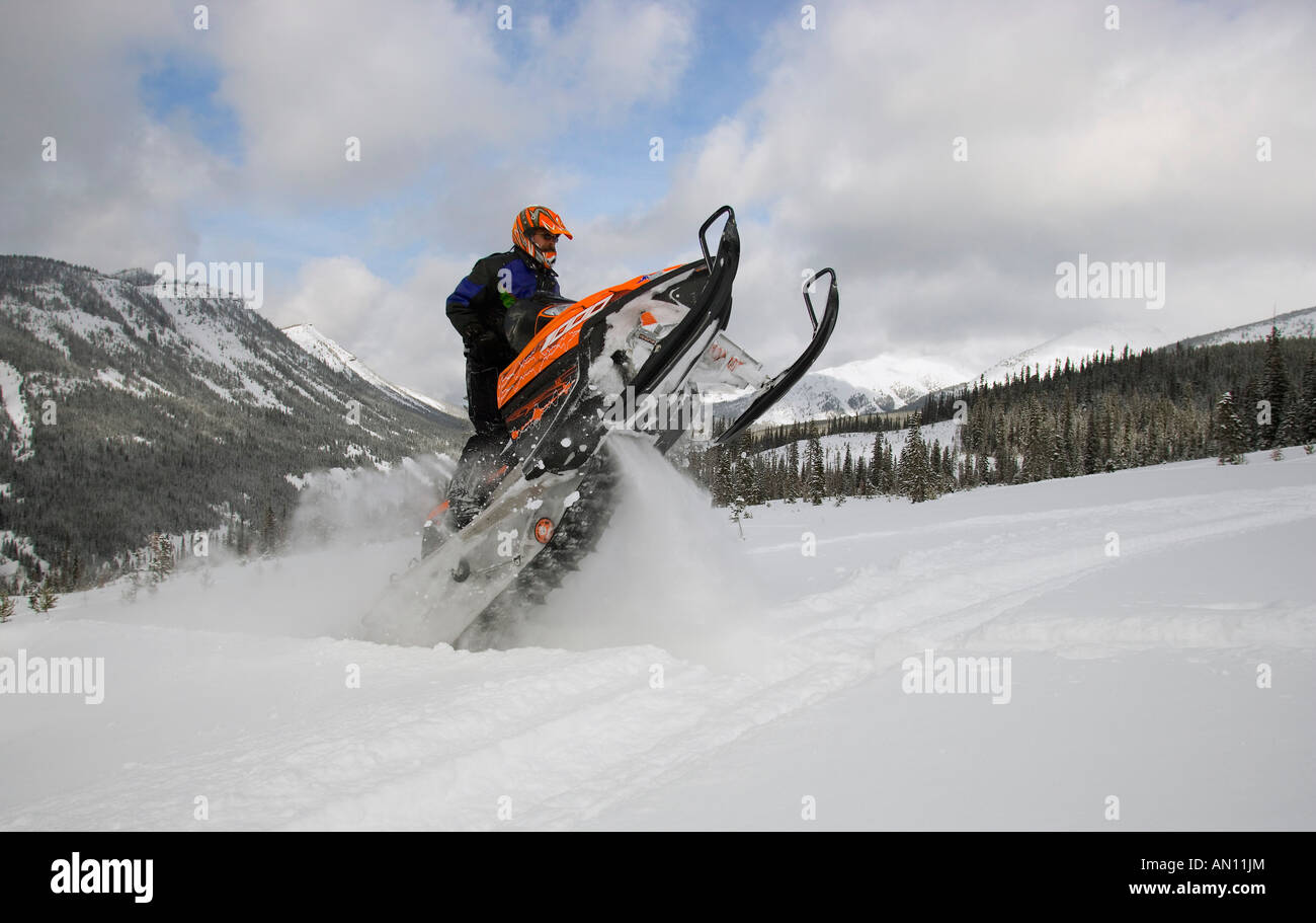 Man doing stunts on a snowmobile Stock Photo - Alamy